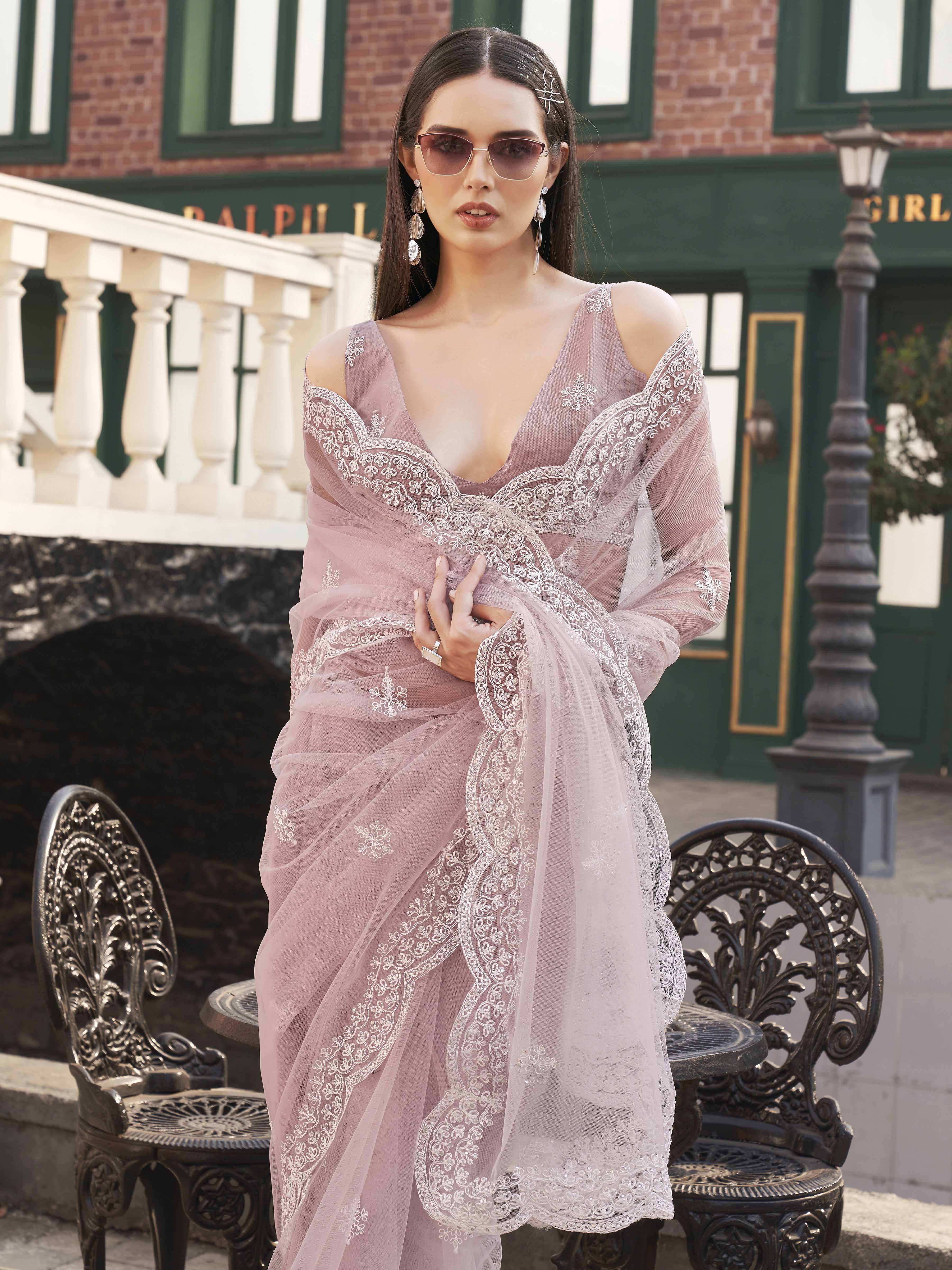 Pink colored embroidered net saree with scalloped border
